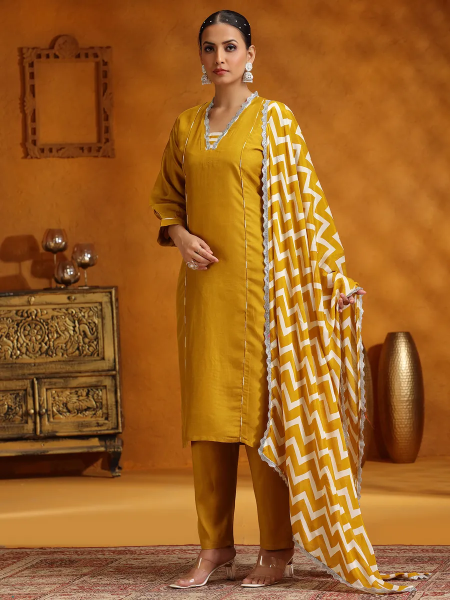 Mustard yellow silk salwar suit with printed dupatta for...