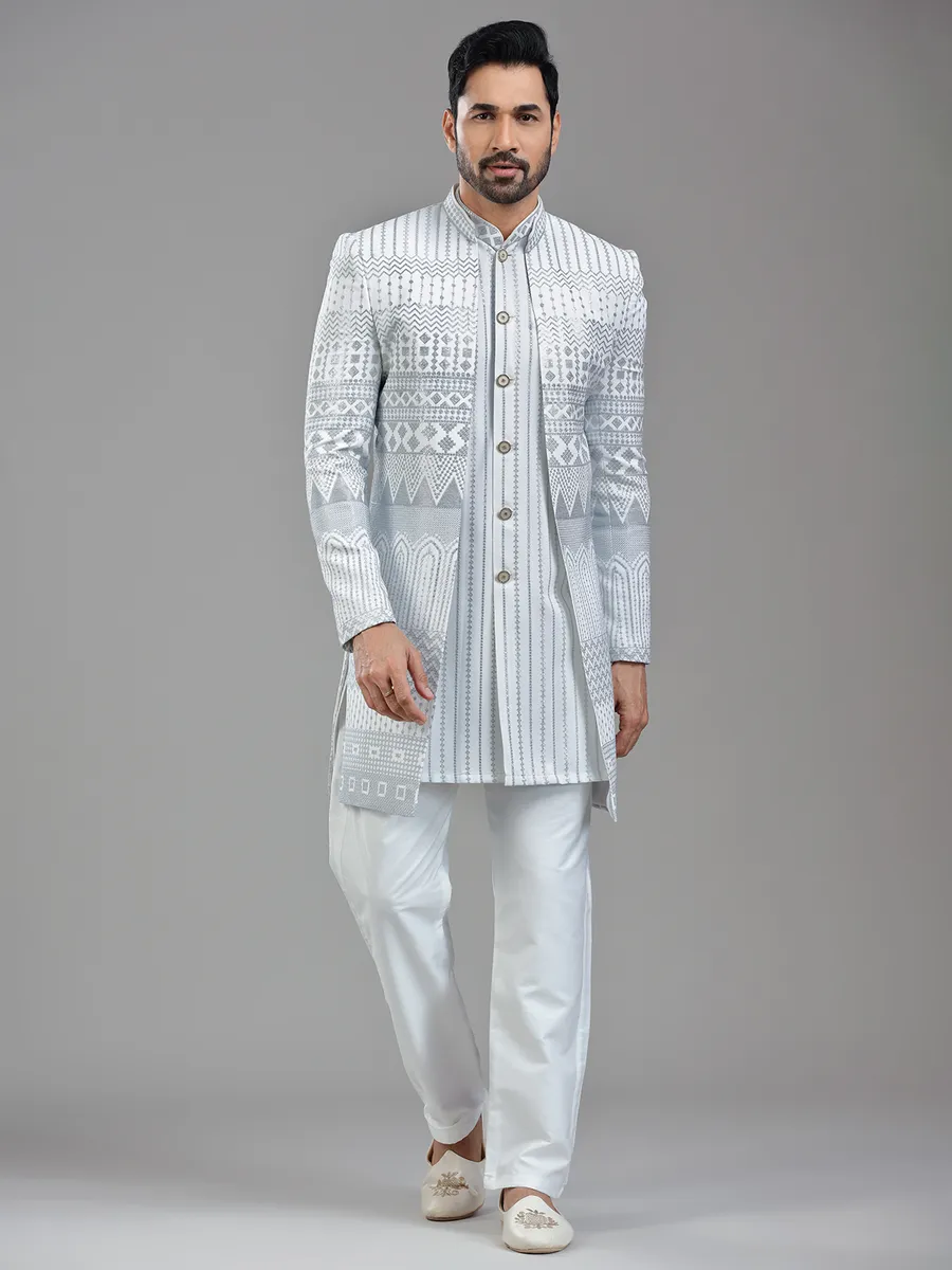 Vibrant white silk jacket style indowestern with sequins and...