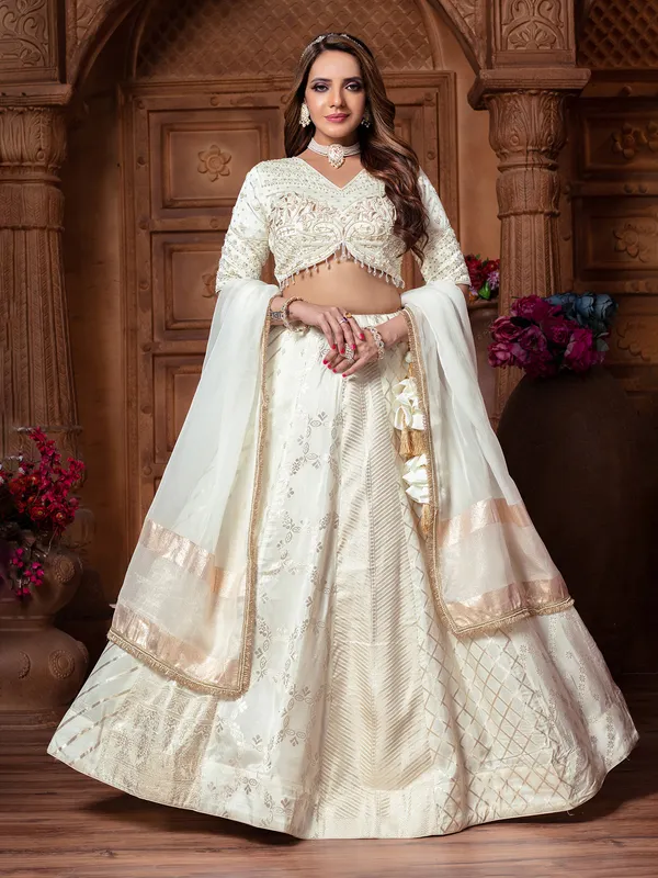 Off white tissue silk lehenga choli in traditional...