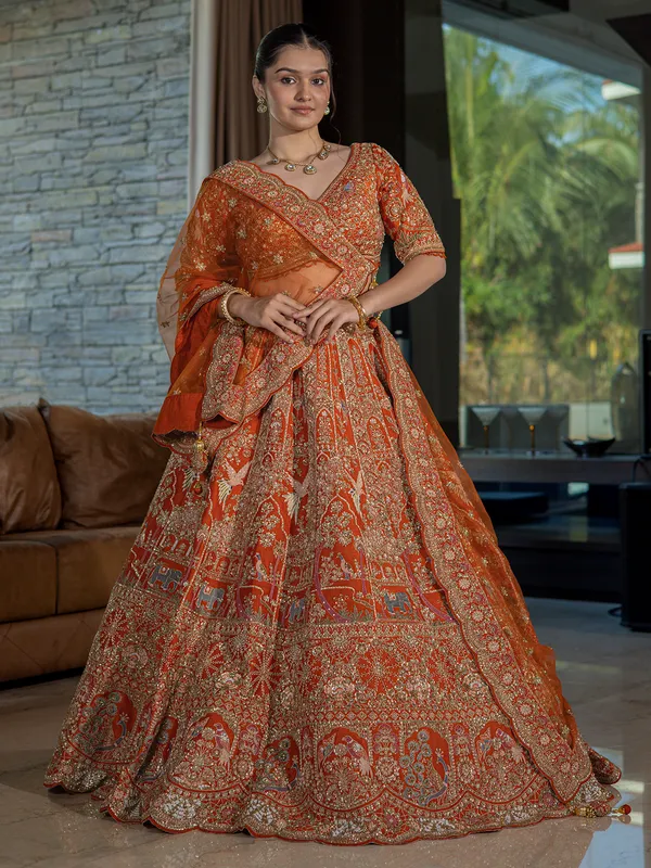 Orange silk bridal lehenga choli with sequins and cutdana...